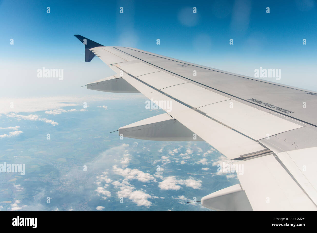 Airplane wing out of window Stock Photo - Alamy