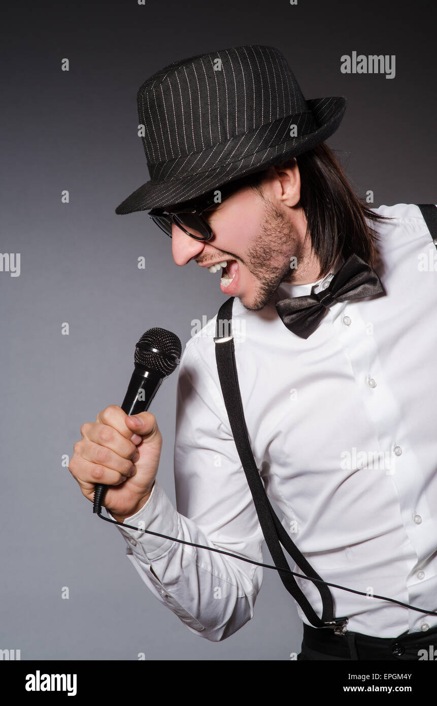Funny singer with microphone at the concert Stock Photo - Alamy
