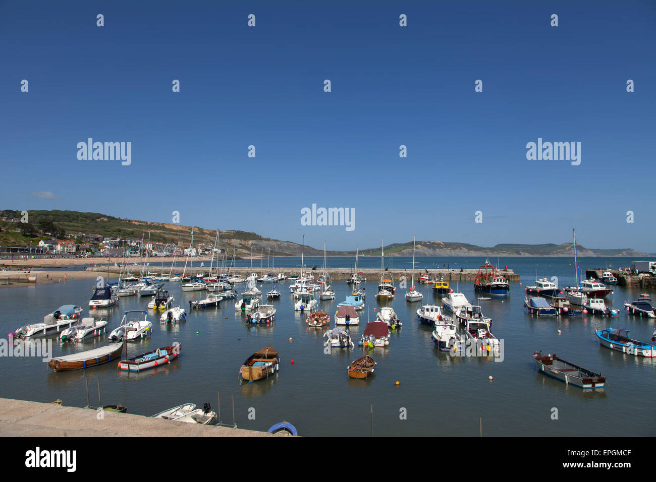 The harbour and the cob at Lyme Regis, Dorset, boats in harbour Stock ...