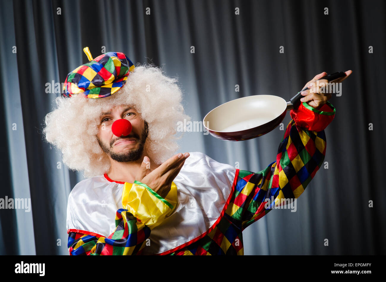 Angry clown with frying pan Stock Photo - Alamy
