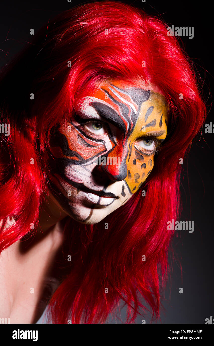 Woman with tiger face in halloween concept Stock Photo - Alamy