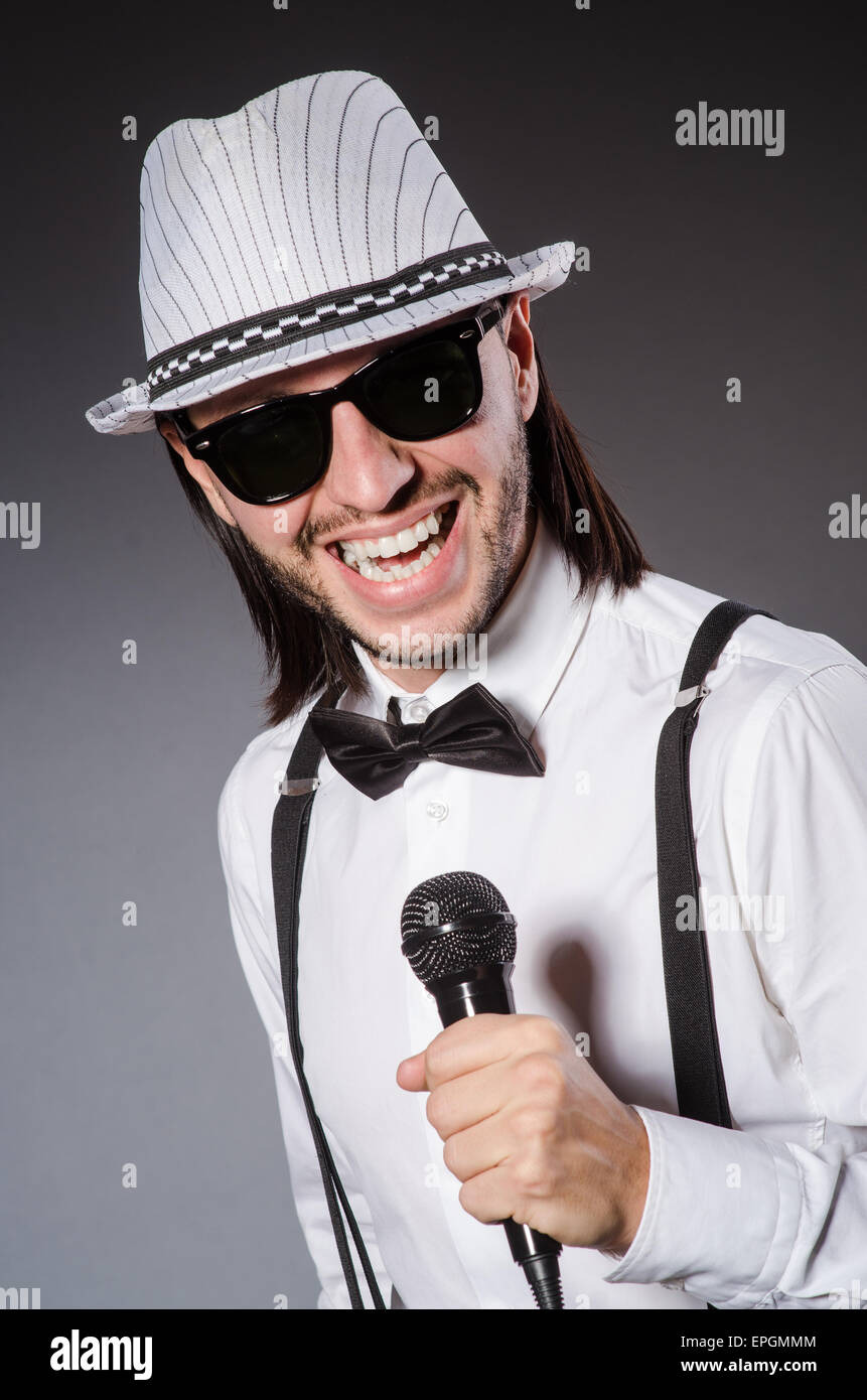 Funny singer with microphone at the concert Stock Photo - Alamy