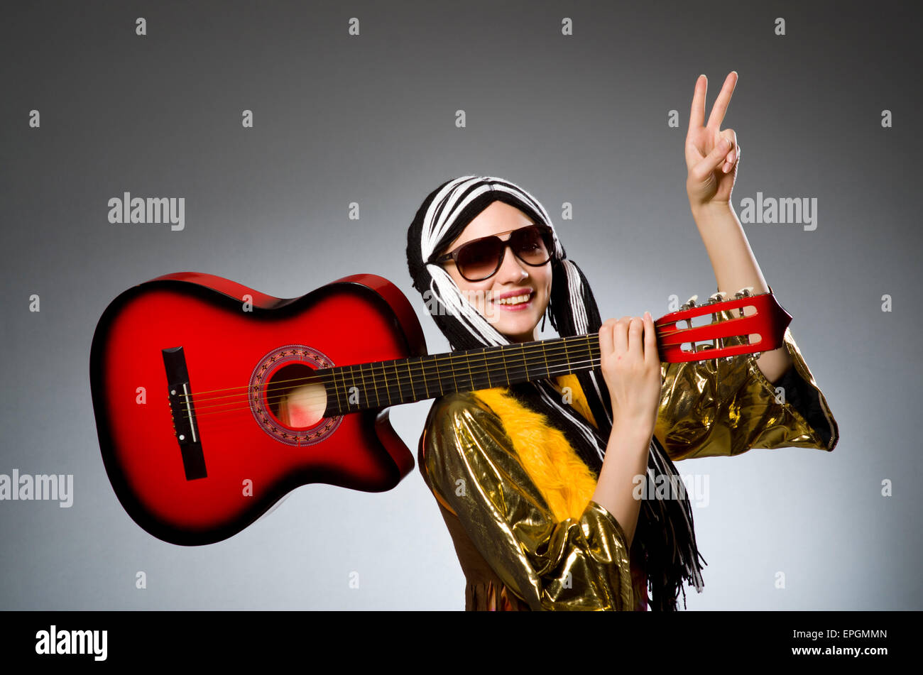 Guitar player with red instrument Stock Photo - Alamy