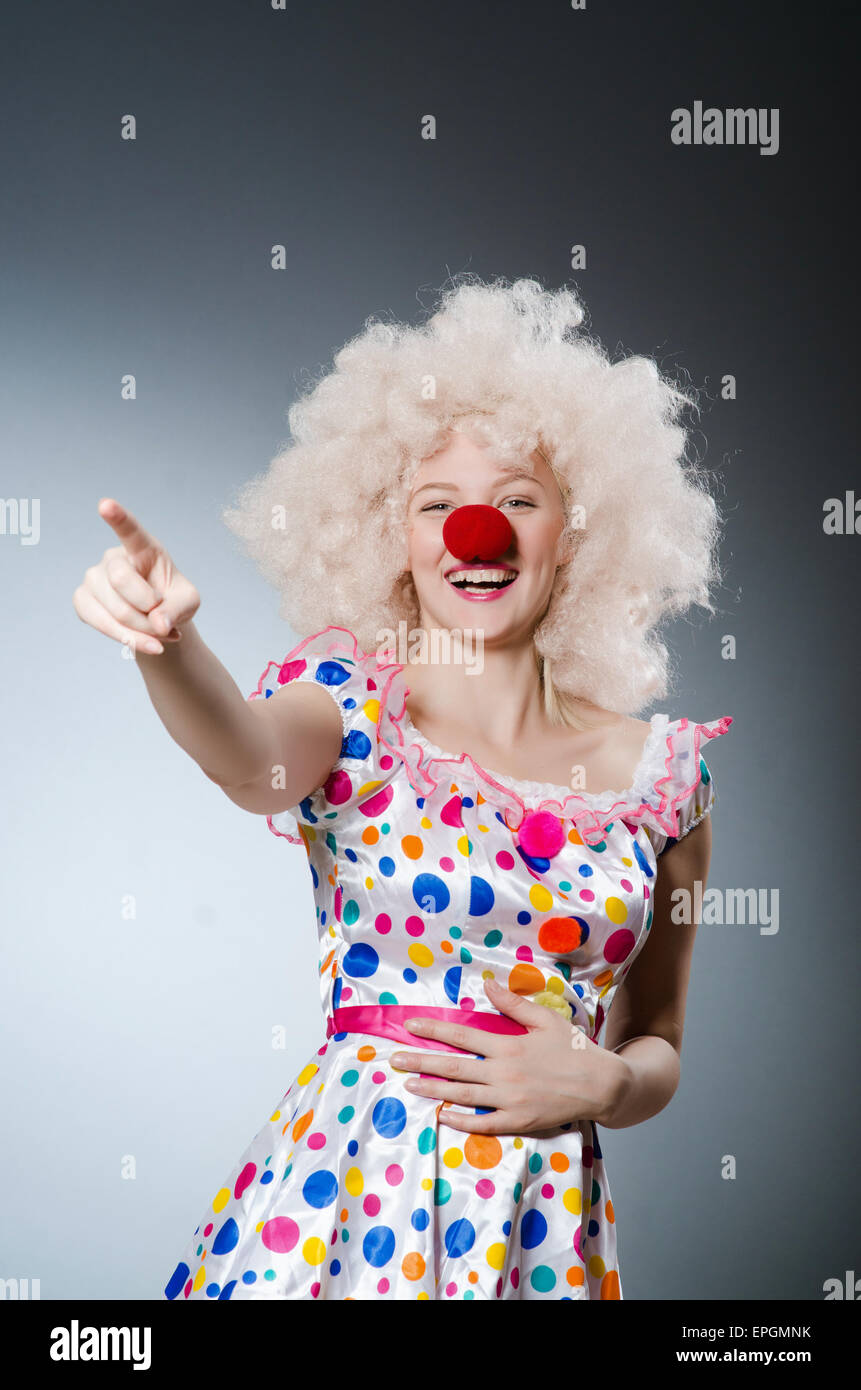 Clown with white wig against grey background Stock Photo - Alamy