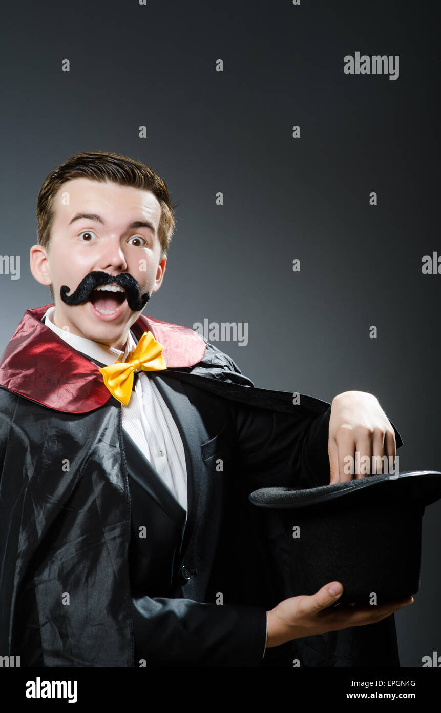 Funny magician with wand and hat Stock Photo - Alamy