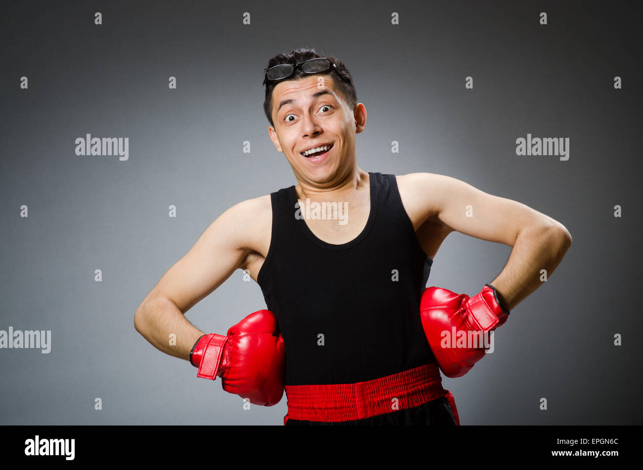Funny boxer with red gloves against dark background Stock Photo - Alamy