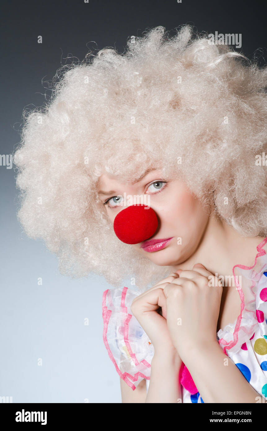 Clown with white wig against grey background Stock Photo - Alamy