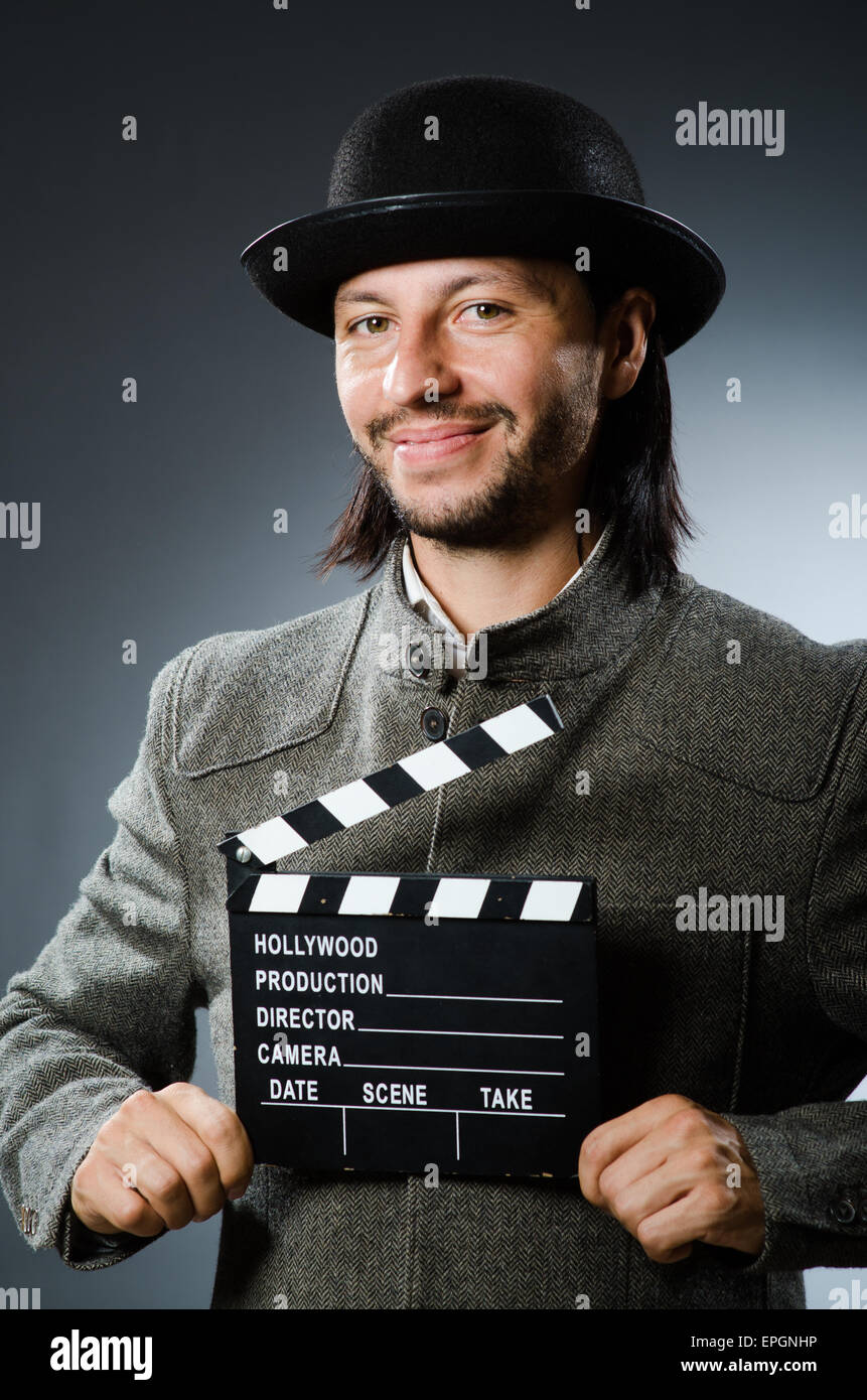 Man with movie clapperboard and hat Stock Photo - Alamy