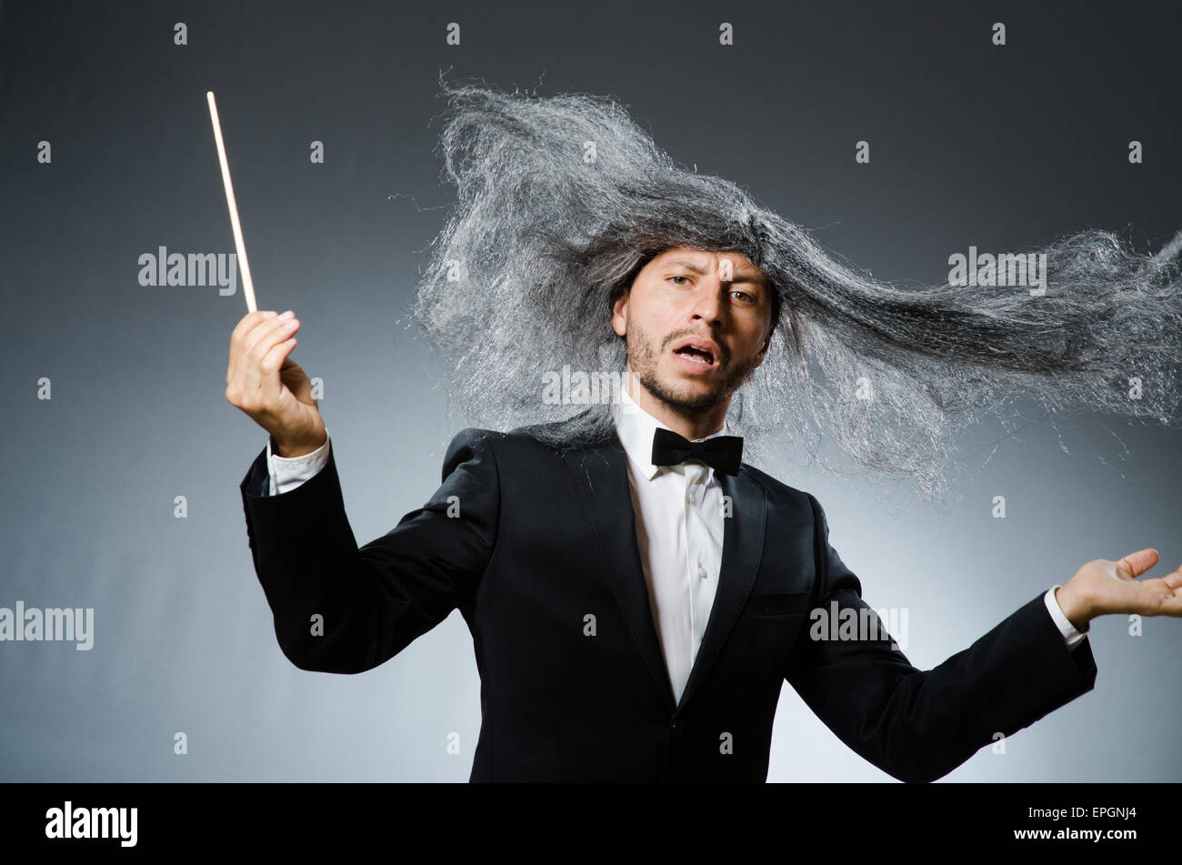 Funny conductor with long grey hair Stock Photo - Alamy