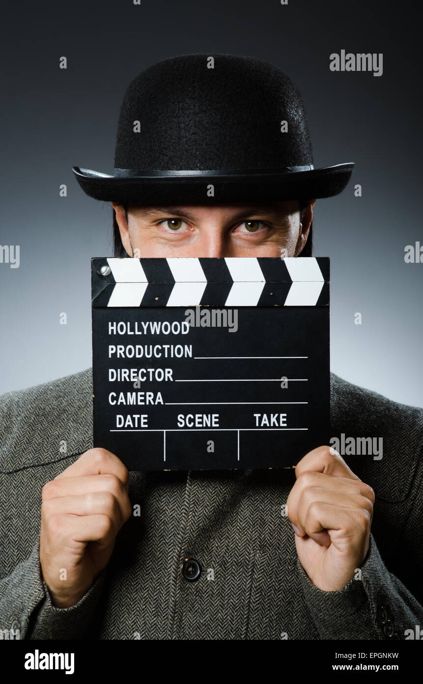 Man with movie clapperboard and hat Stock Photo - Alamy