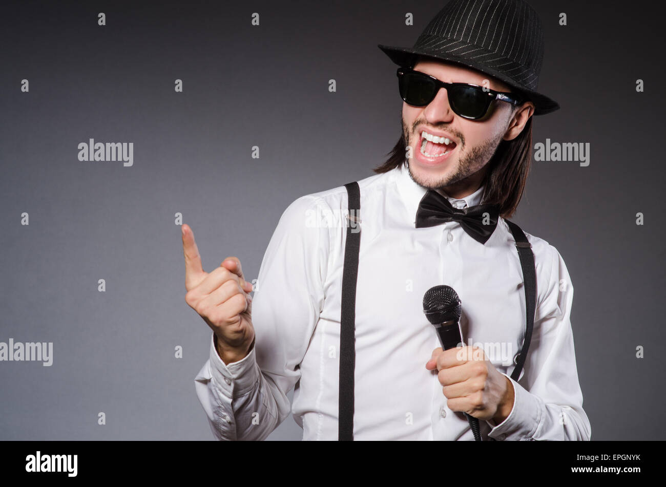 Funny singer with microphone at the concert Stock Photo - Alamy