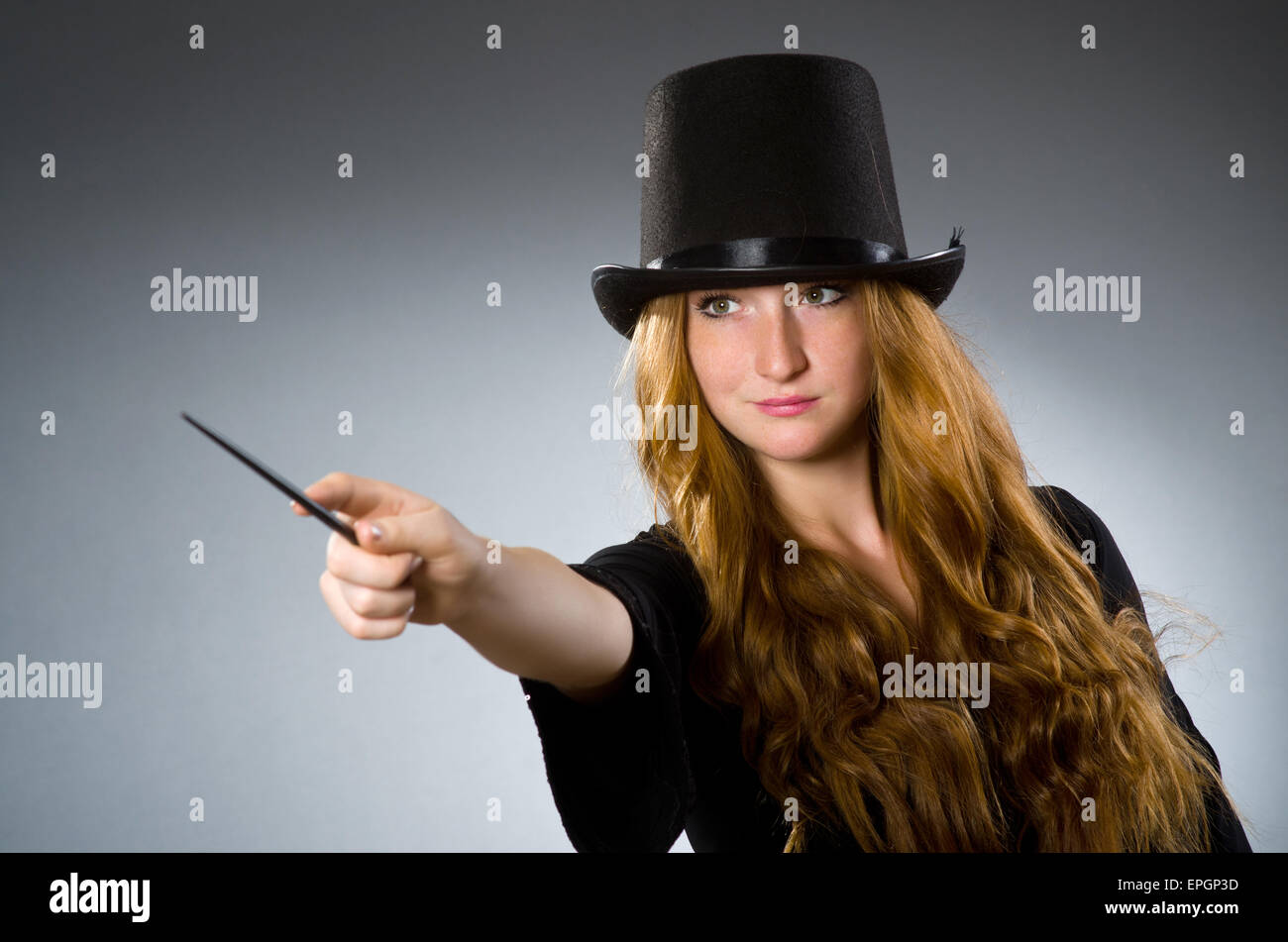 Woman magician doing her tricks with wand Stock Photo - Alamy