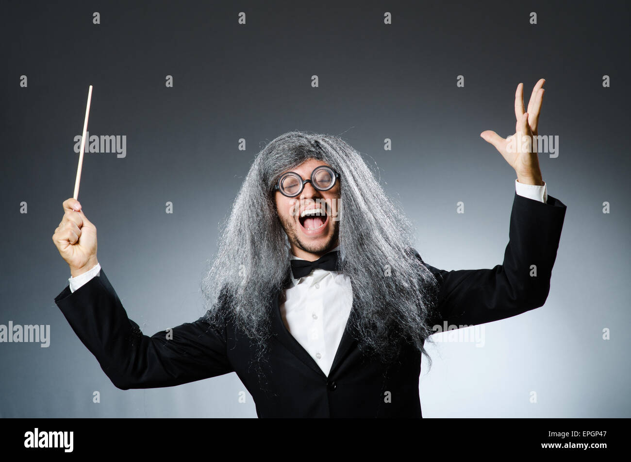 Funny conductor with long grey hair Stock Photo - Alamy