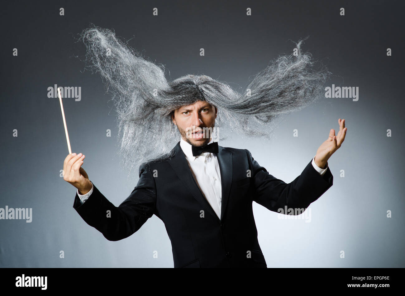 Funny conductor with long grey hair Stock Photo - Alamy