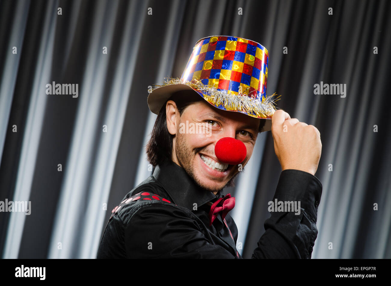 Funny clown in humorous concept against curtain Stock Photo - Alamy