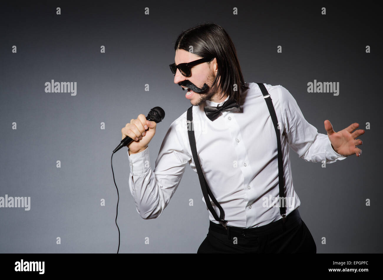 Funny singer with microphone at the concert Stock Photo - Alamy
