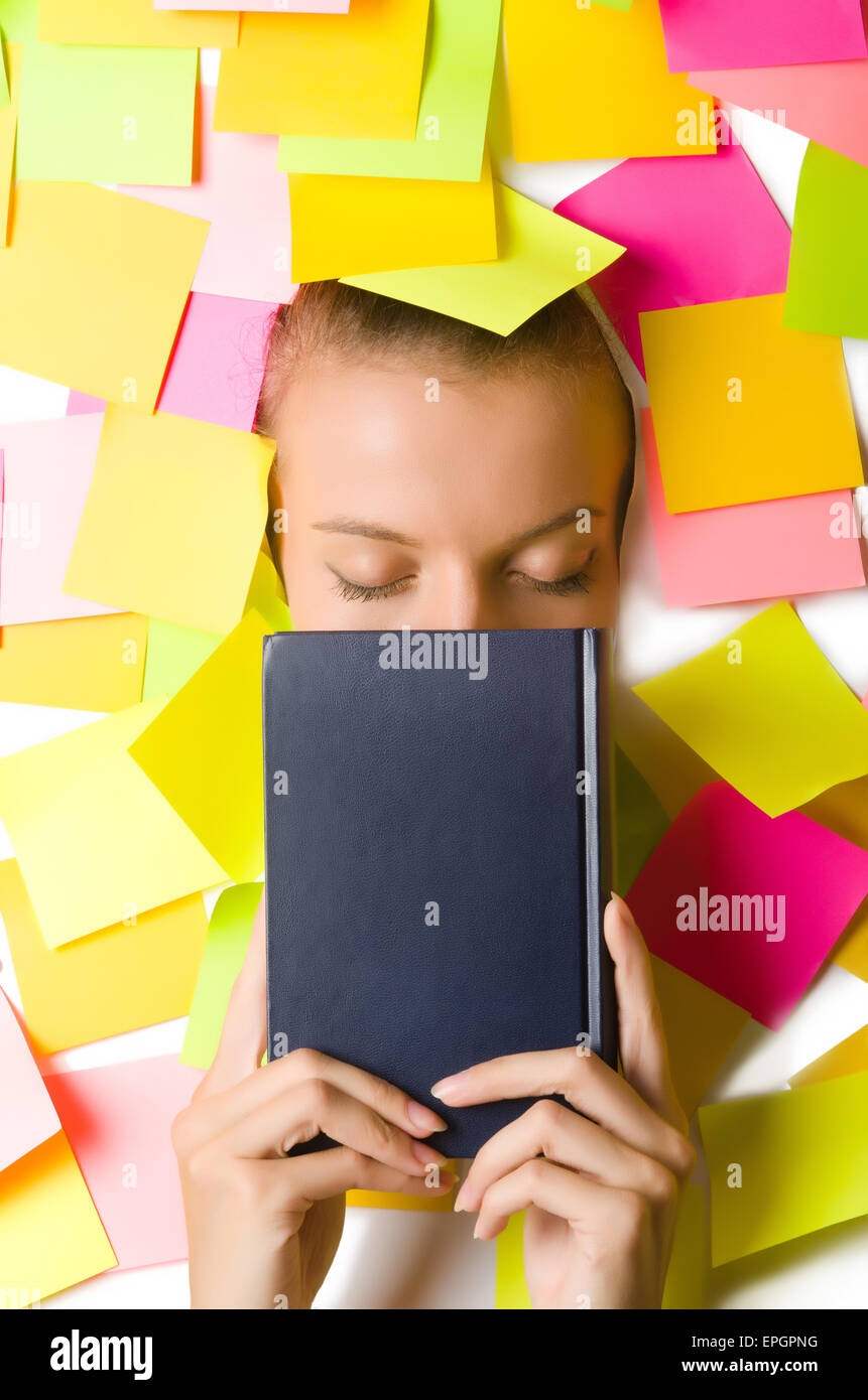 Woman with many reminder notes reading book Stock Photo - Alamy