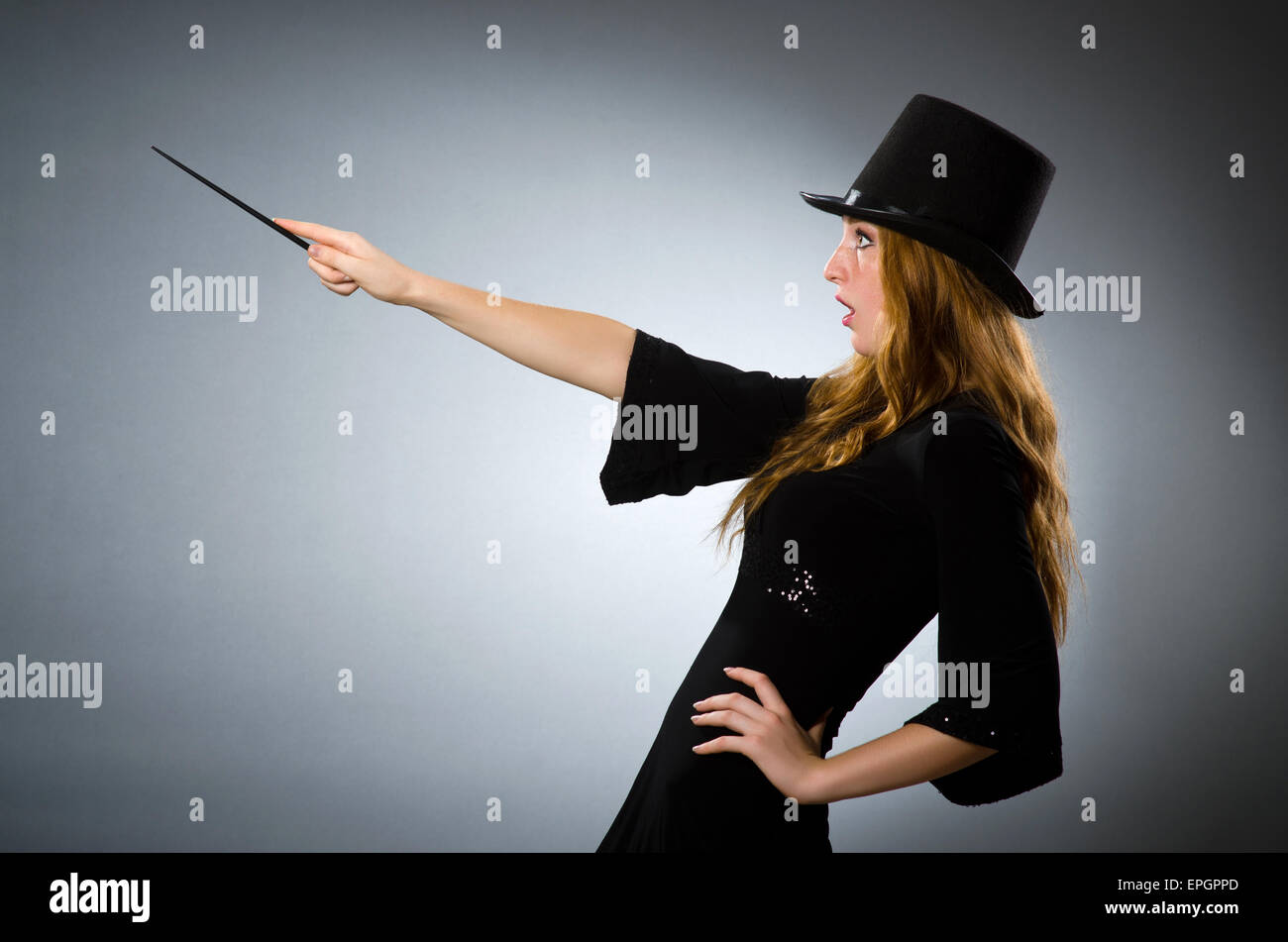 Woman magician doing her tricks with wand Stock Photo - Alamy