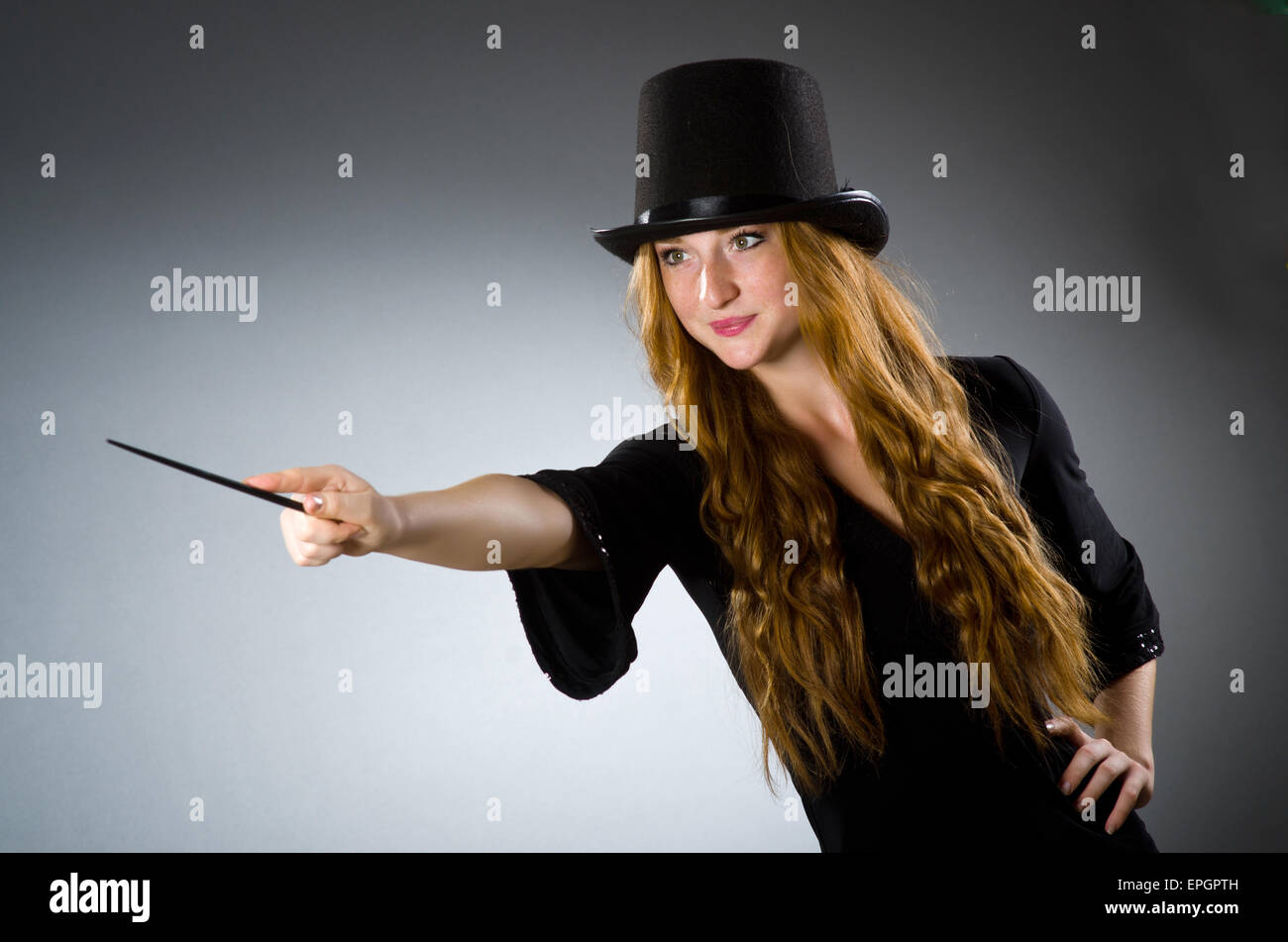 Woman magician doing her tricks with wand Stock Photo - Alamy