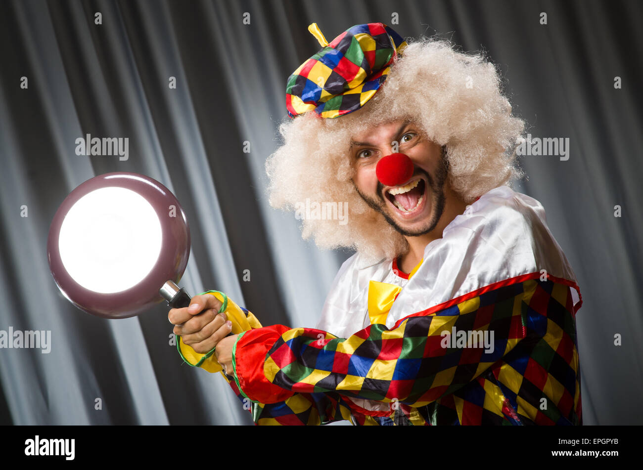 Angry clown with frying pan Stock Photo - Alamy