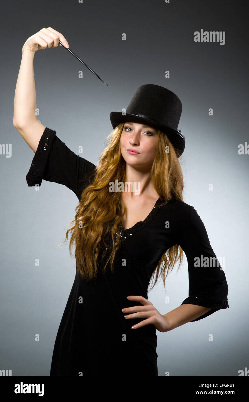 Woman magician doing her tricks with wand Stock Photo - Alamy
