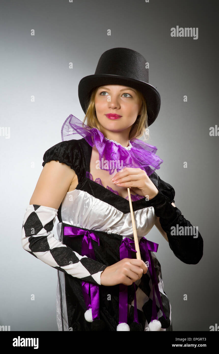 Woman magician doing her tricks with wand Stock Photo - Alamy