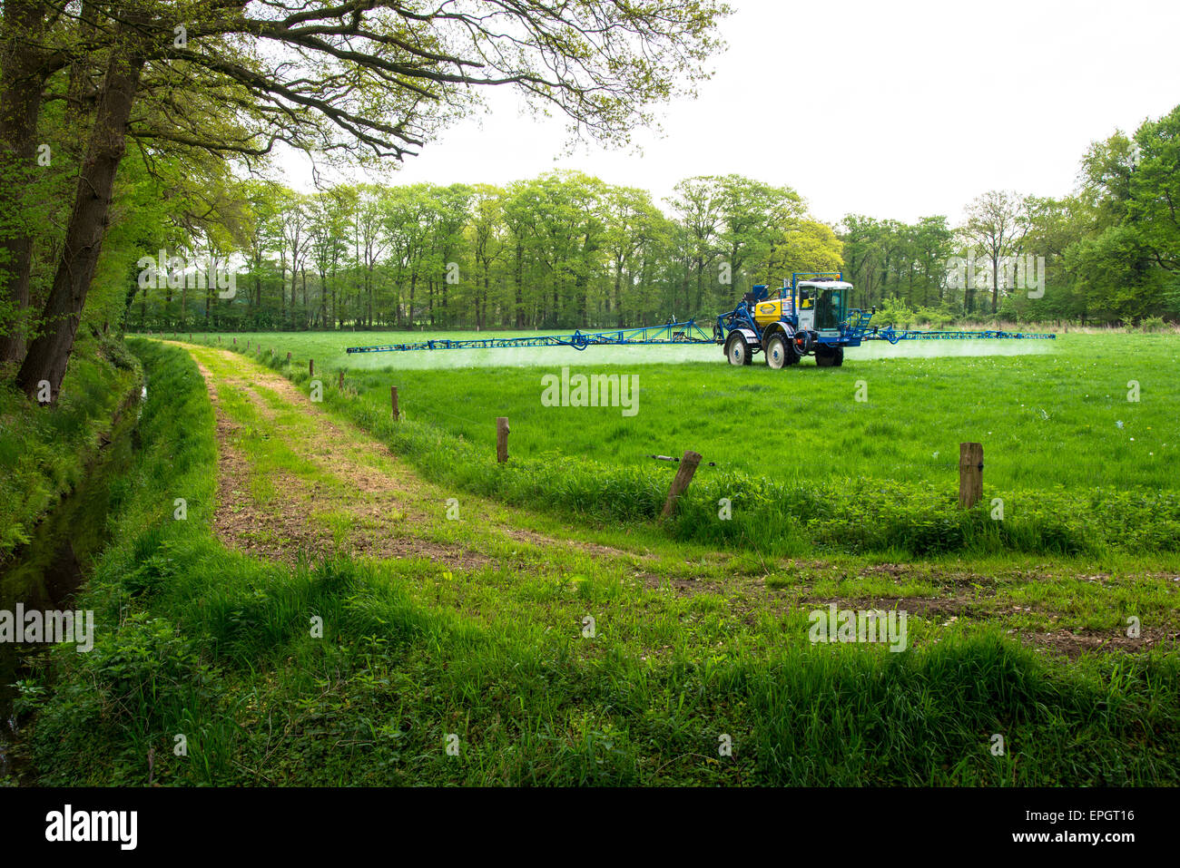 farmer with tractor sprays fertilizer at his field Stock Photo - Alamy