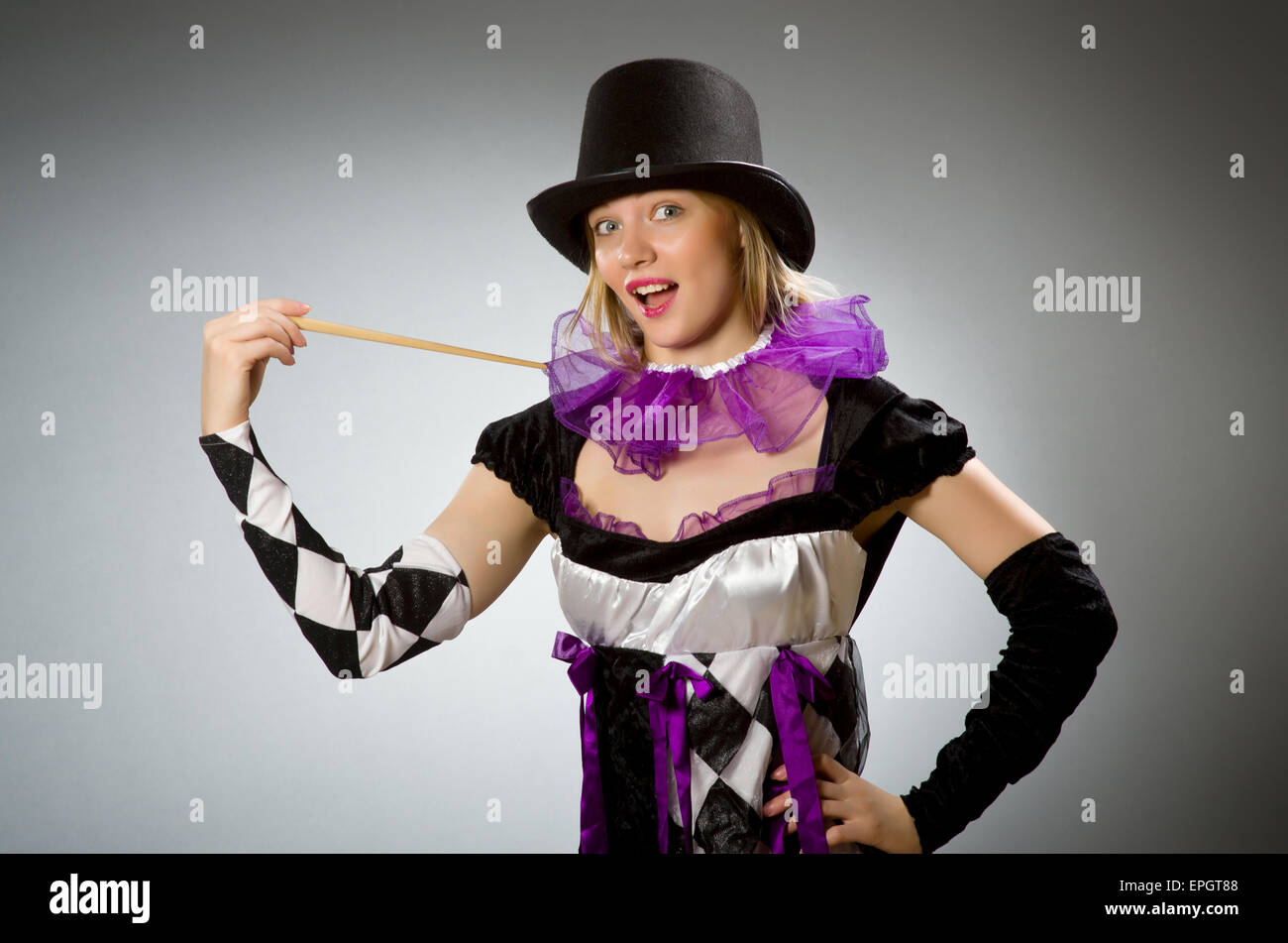 Woman magician doing her tricks with wand Stock Photo - Alamy