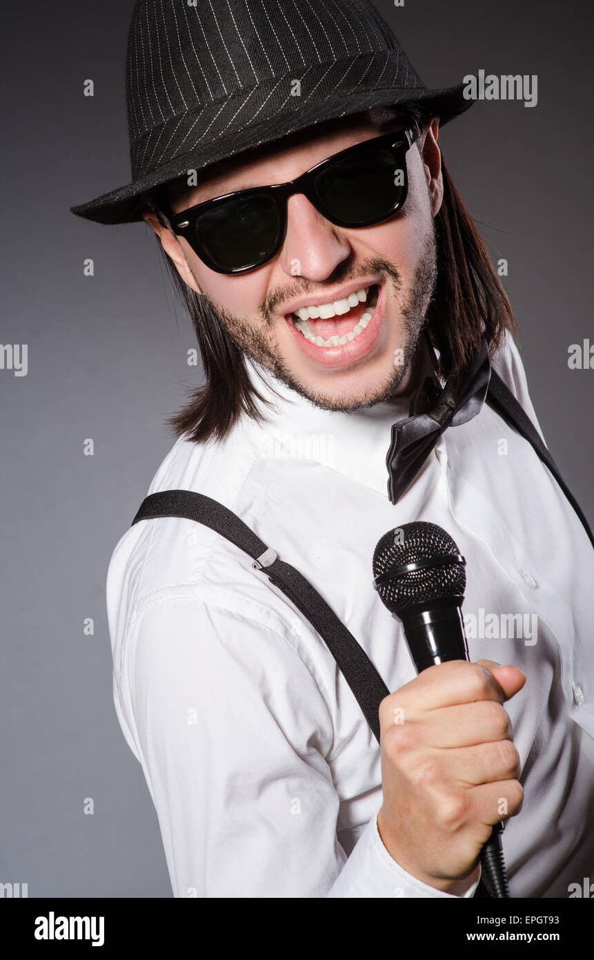 Funny singer with microphone at the concert Stock Photo - Alamy
