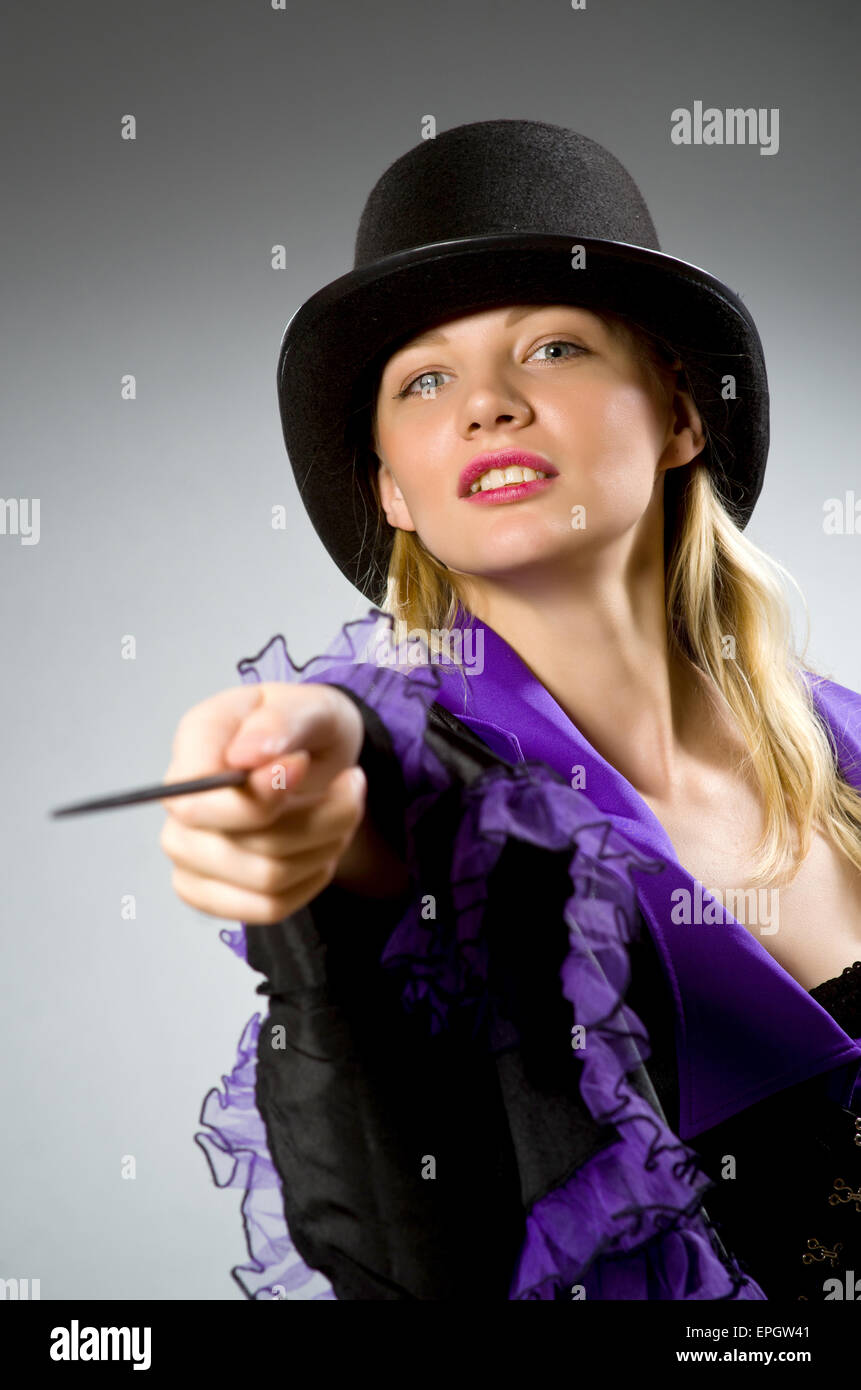 Woman magician doing her tricks with wand Stock Photo - Alamy