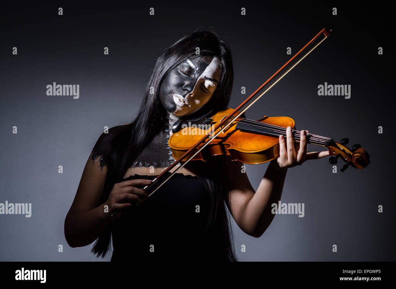 Scary monster playing violing in halloween concept Stock Photo - Alamy