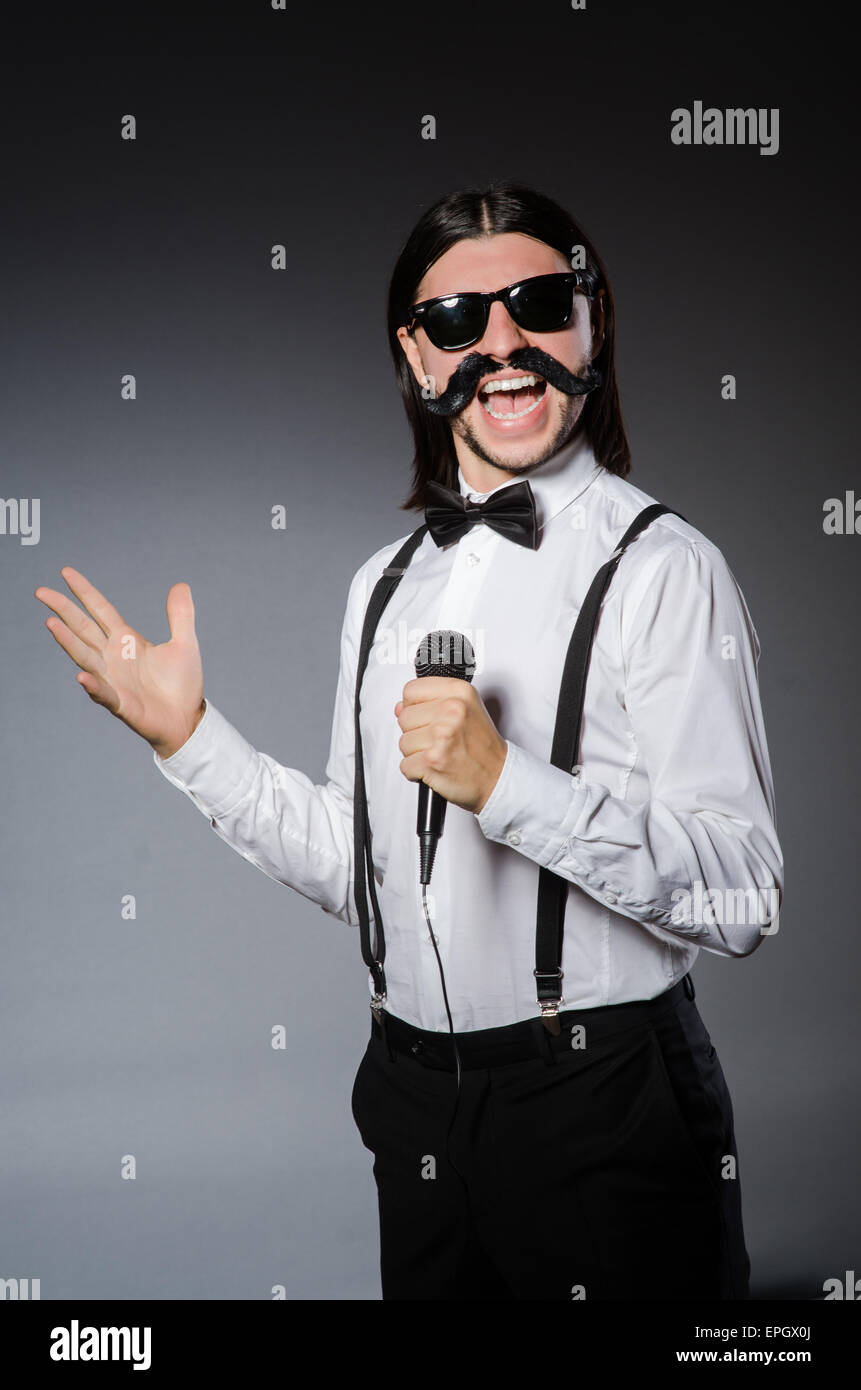 Funny singer with microphone at the concert Stock Photo - Alamy