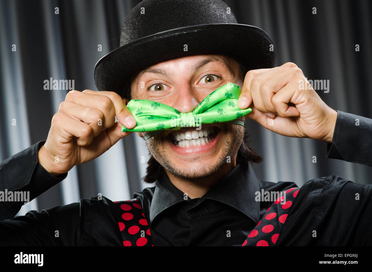 Funny clown in humorous concept against curtain Stock Photo - Alamy