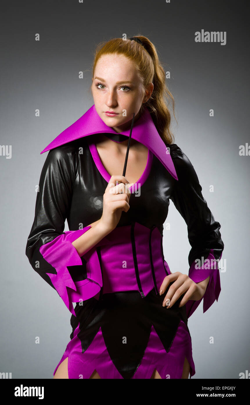 Female magician doing tricks on grey background Stock Photo - Alamy