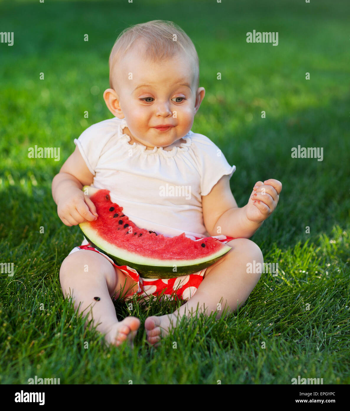 Happy baby with slice of watermelon Stock Photo - Alamy