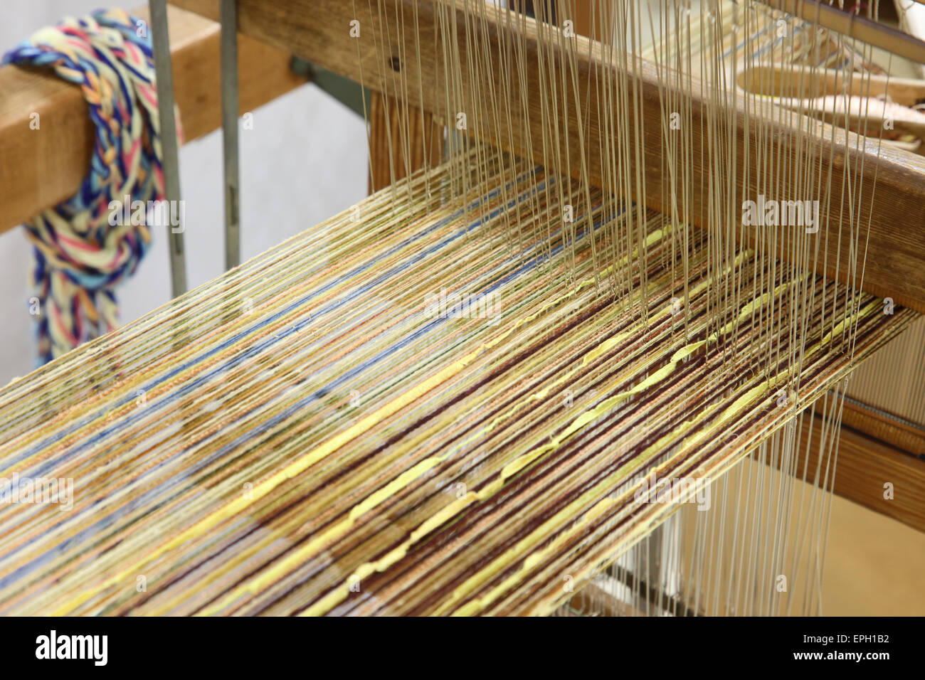 Colorful threads on a loom Stock Photo - Alamy