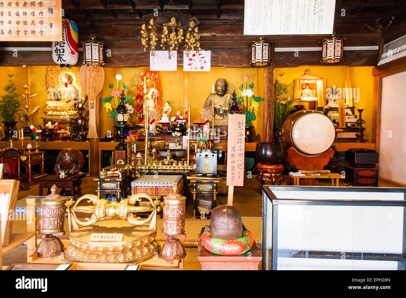 Interior of small Buddhist temple, altar with various aspects of the ...