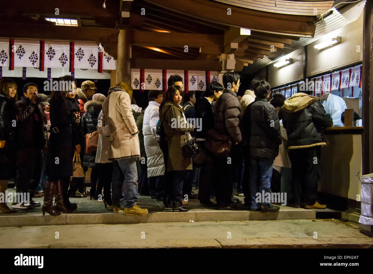 Japanese Shinto shrine at the new year with people queuing in front of ...