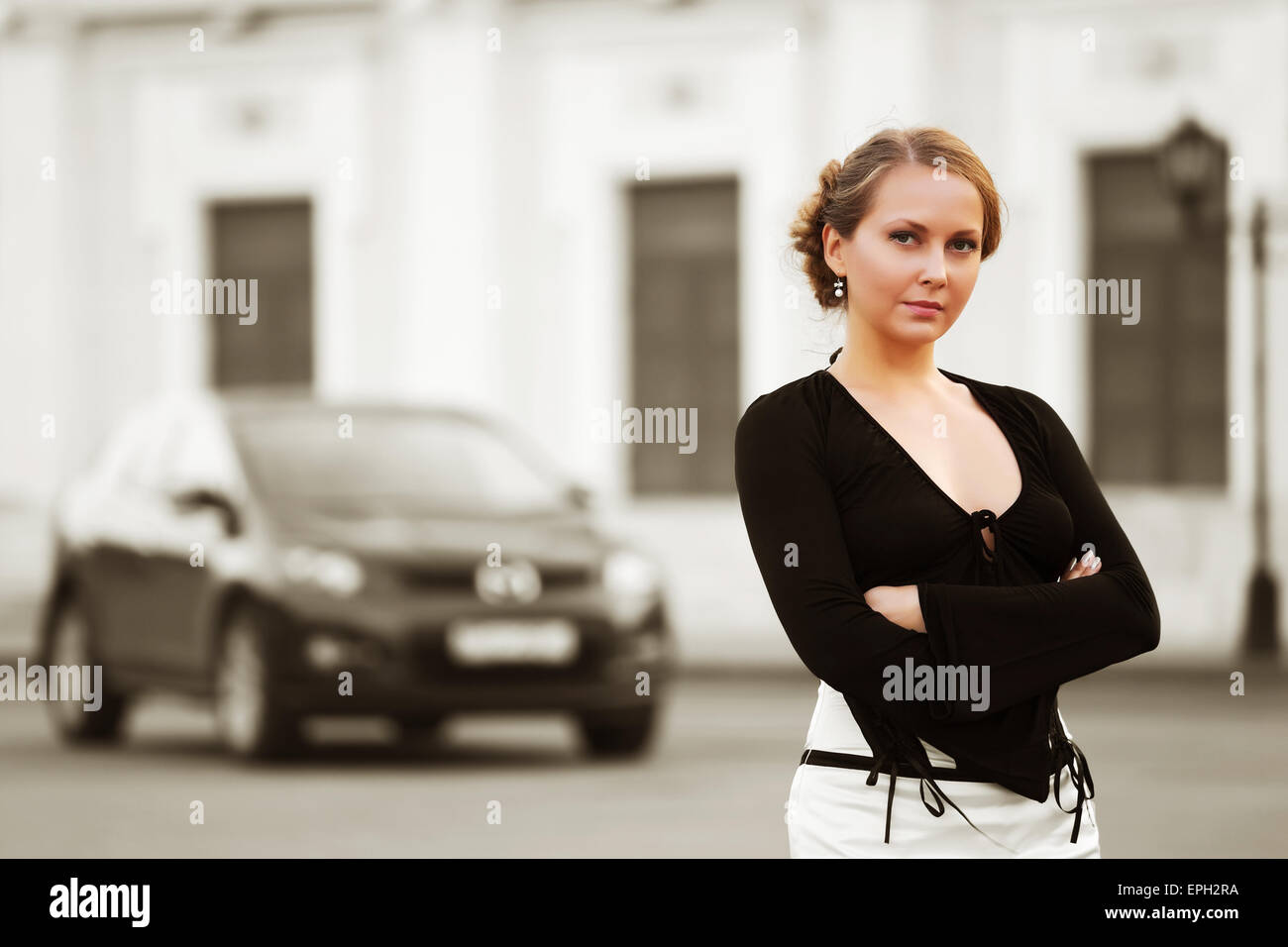 Young woman against a car parking Stock Photo - Alamy