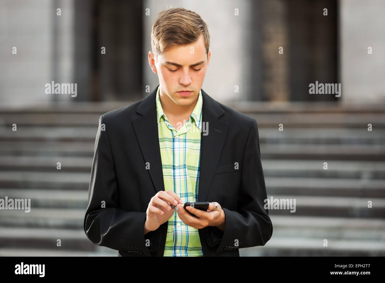 Young man calling on the mobile phone outdoor Stock Photo - Alamy