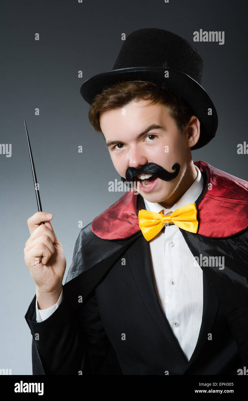 Funny magician with wand and hat Stock Photo - Alamy