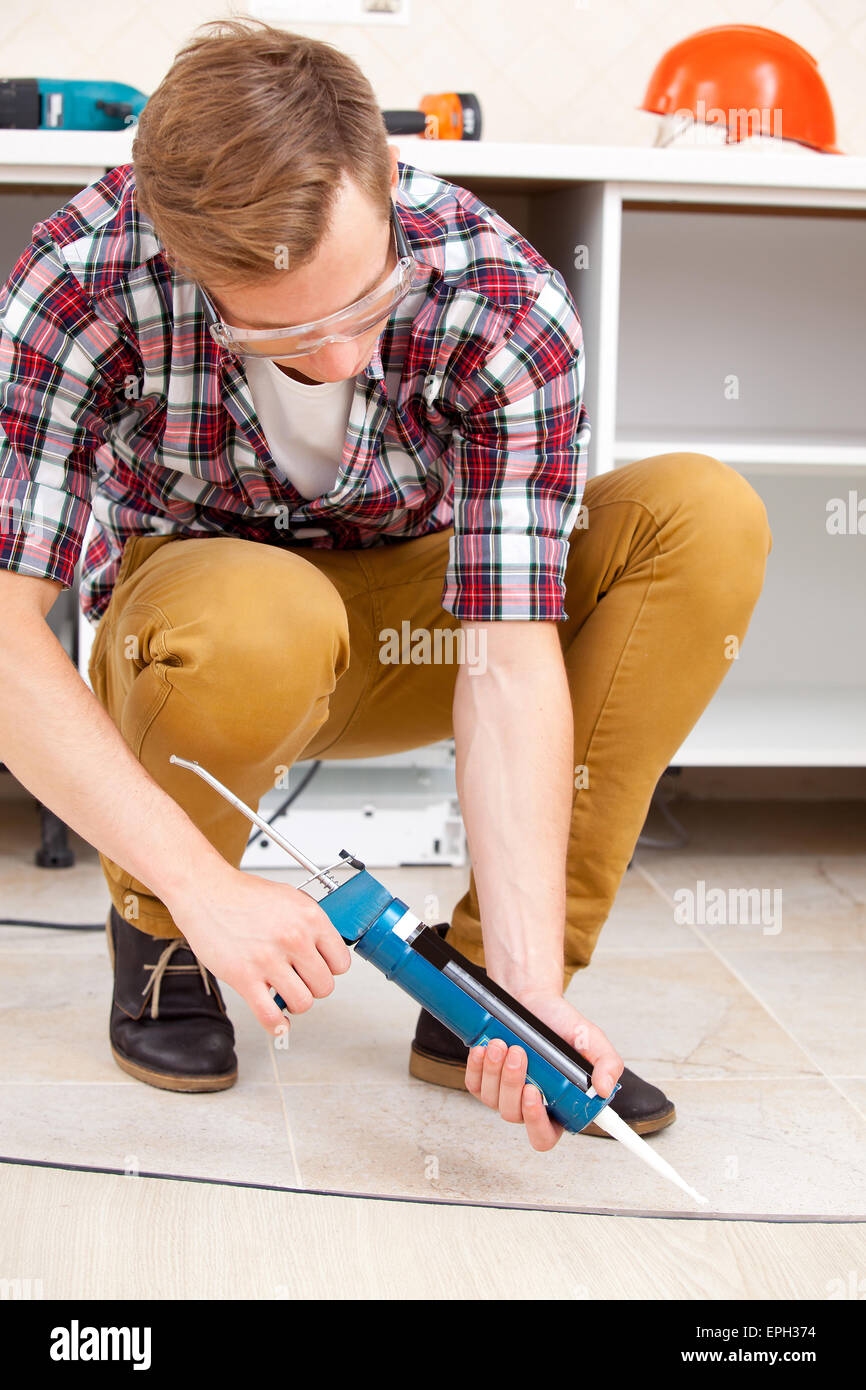 repairman repairing the floor Stock Photo - Alamy