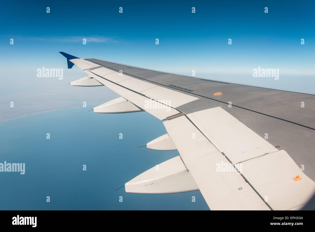 Airplane wing out of window Stock Photo - Alamy