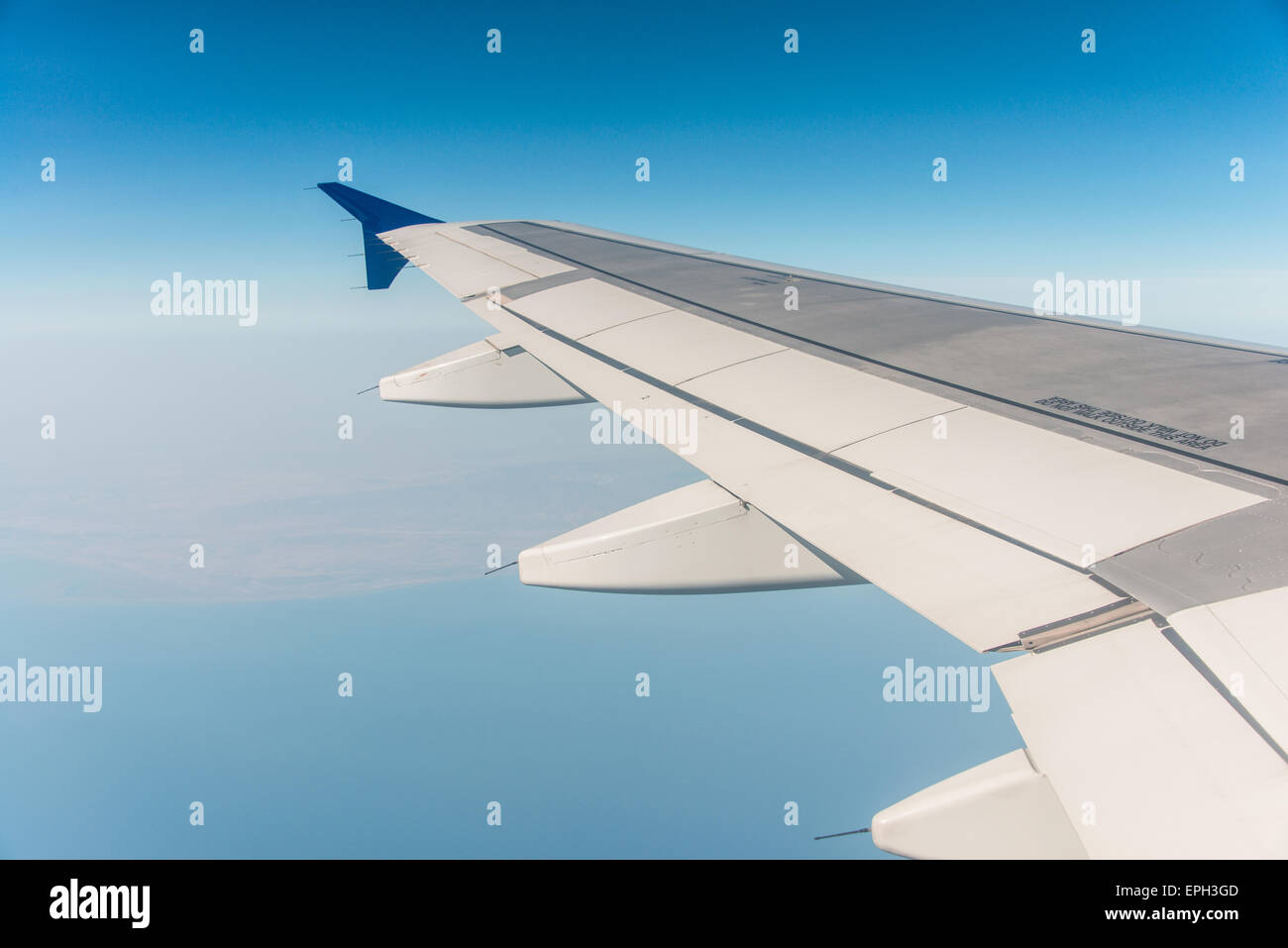 Airplane wing out of window Stock Photo - Alamy