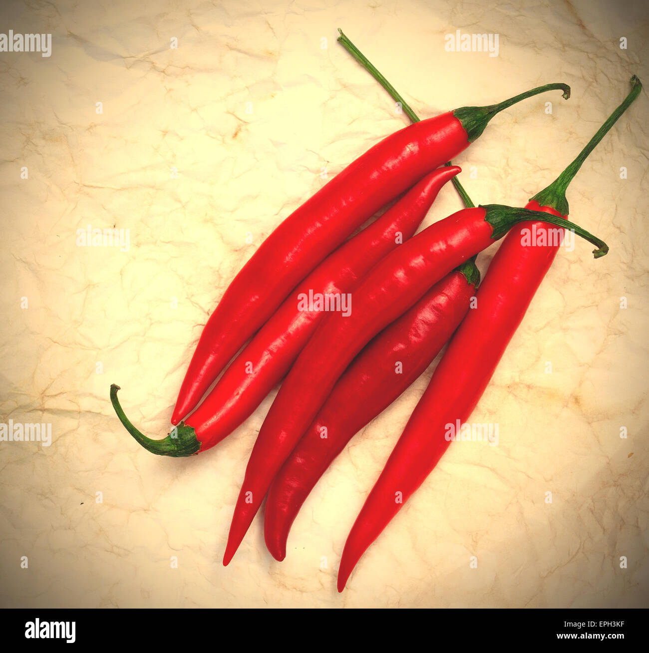 chili pepper on a old paper surface Stock Photo - Alamy