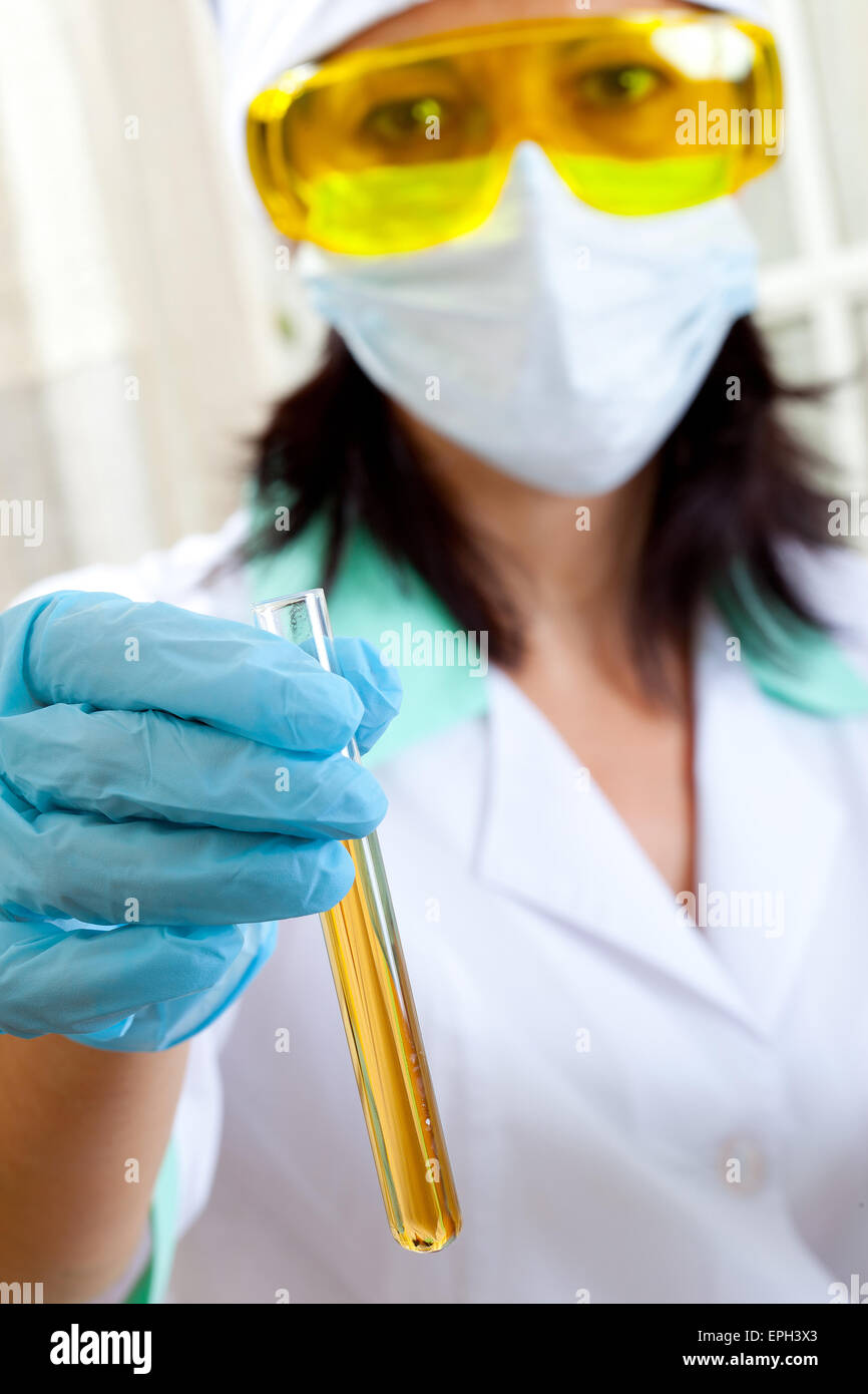 doctor shows a test tube of yellow solution Stock Photo - Alamy