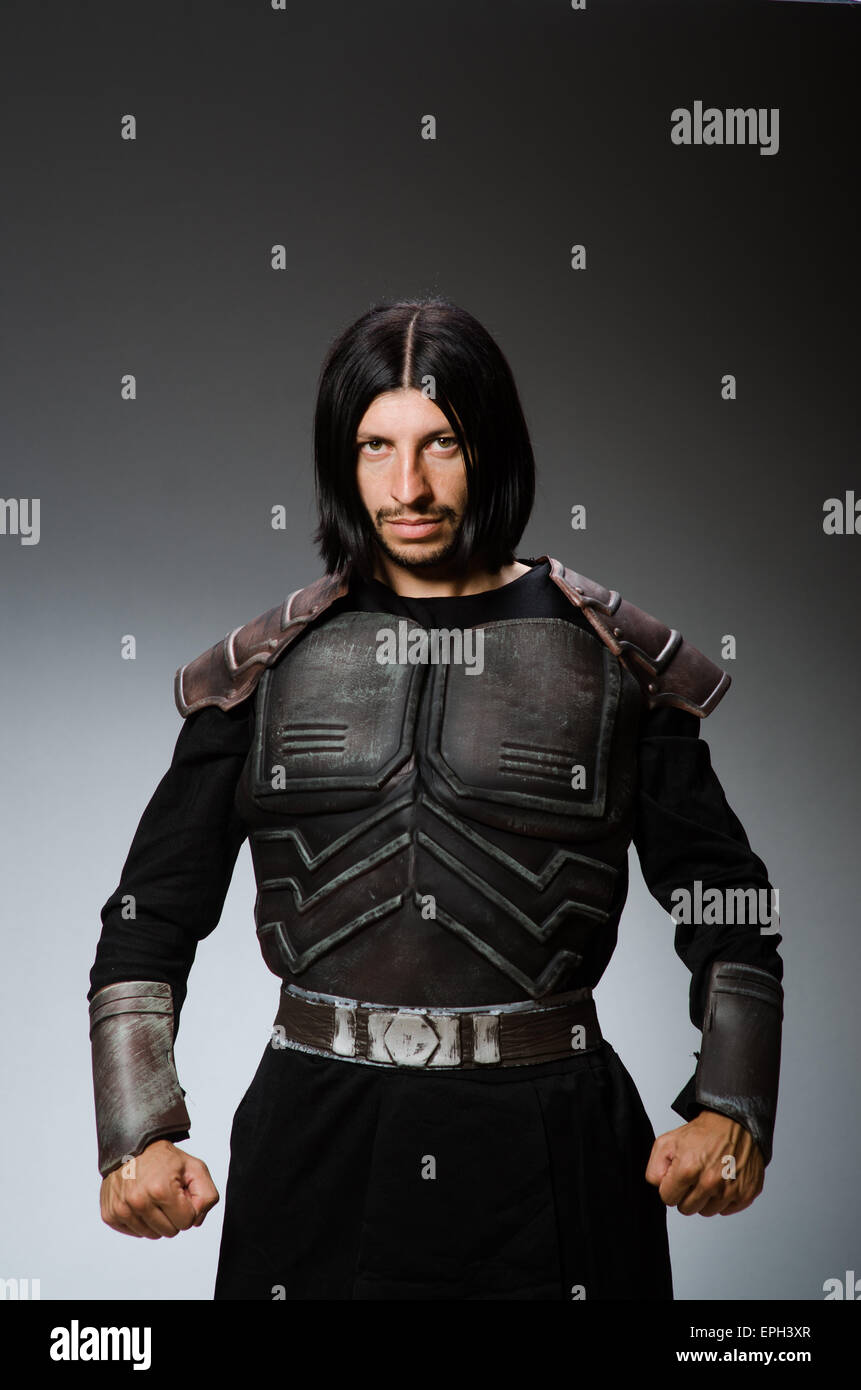 Angry warrior against dark background Stock Photo - Alamy