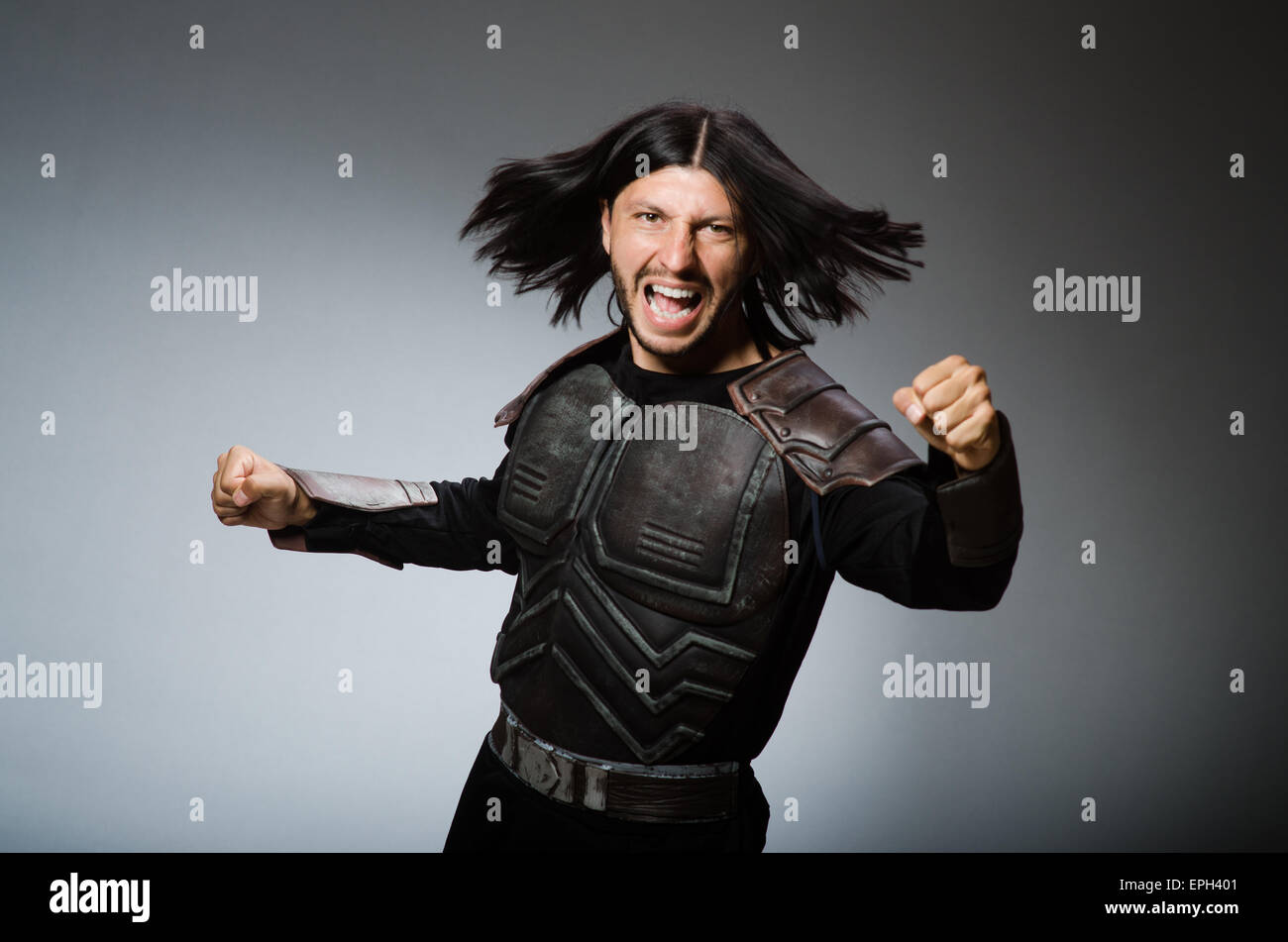 Angry warrior against dark background Stock Photo - Alamy