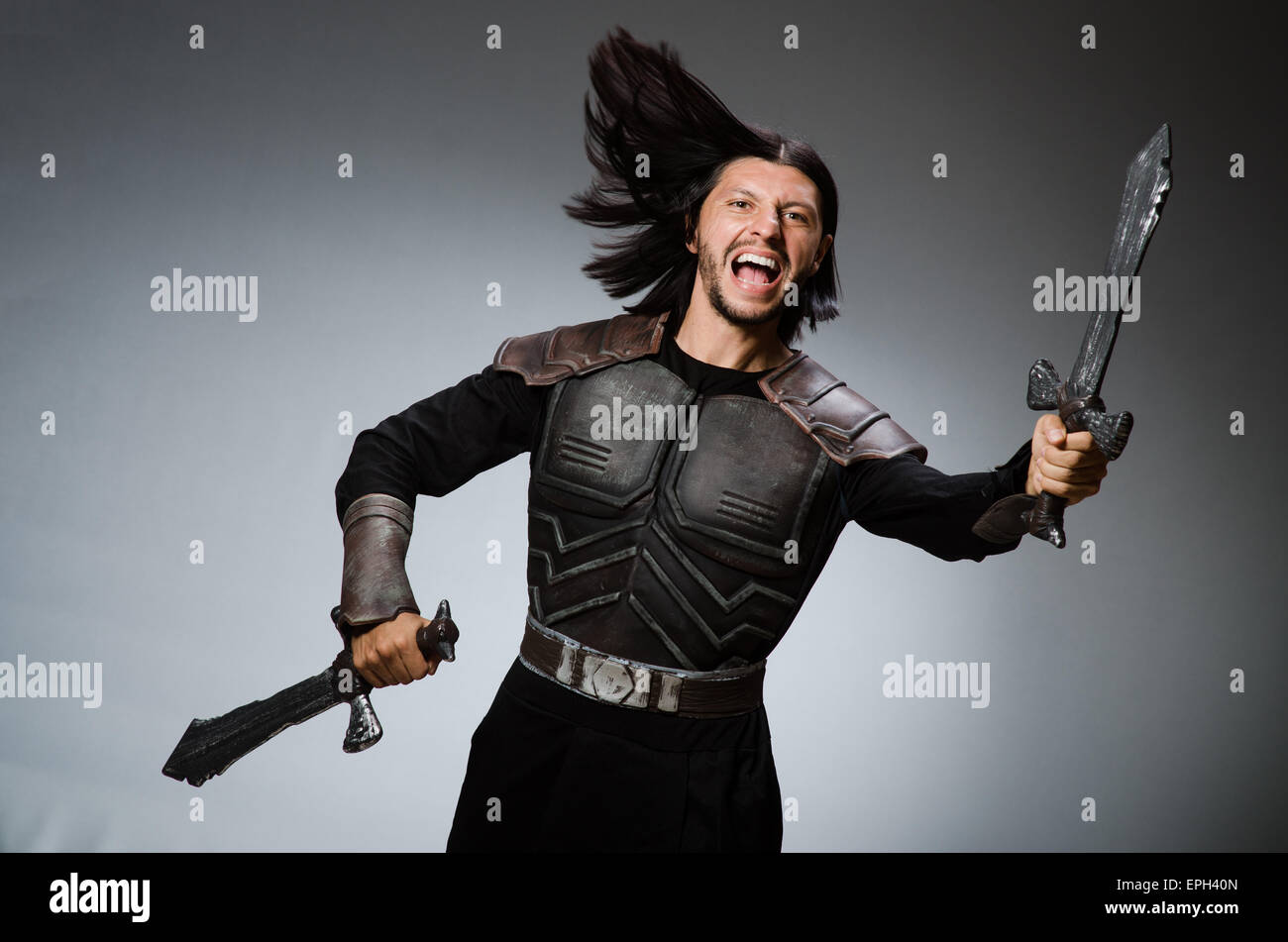 Angry knight with sword against dark background Stock Photo - Alamy