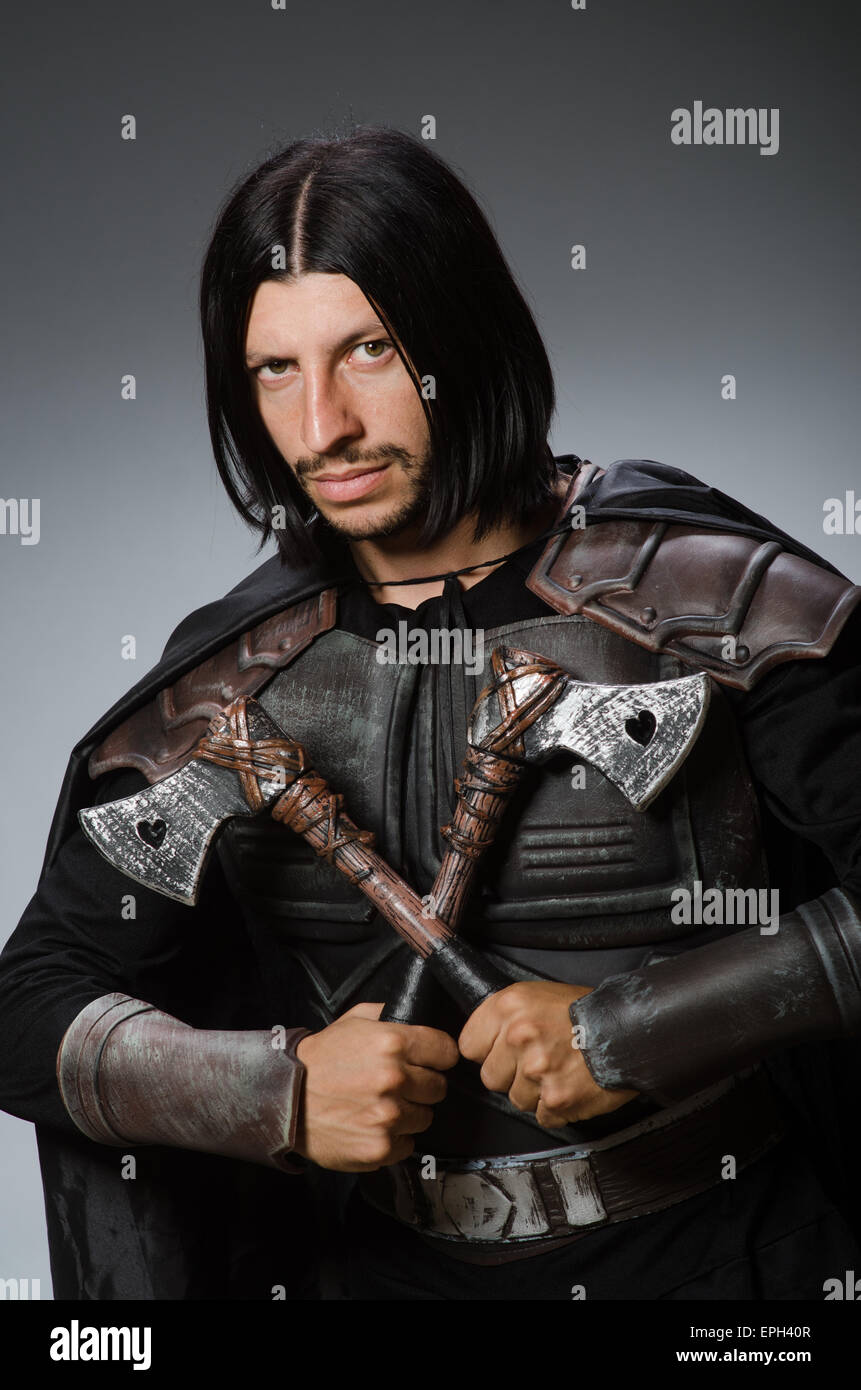 Knight with axe against dark background Stock Photo - Alamy
